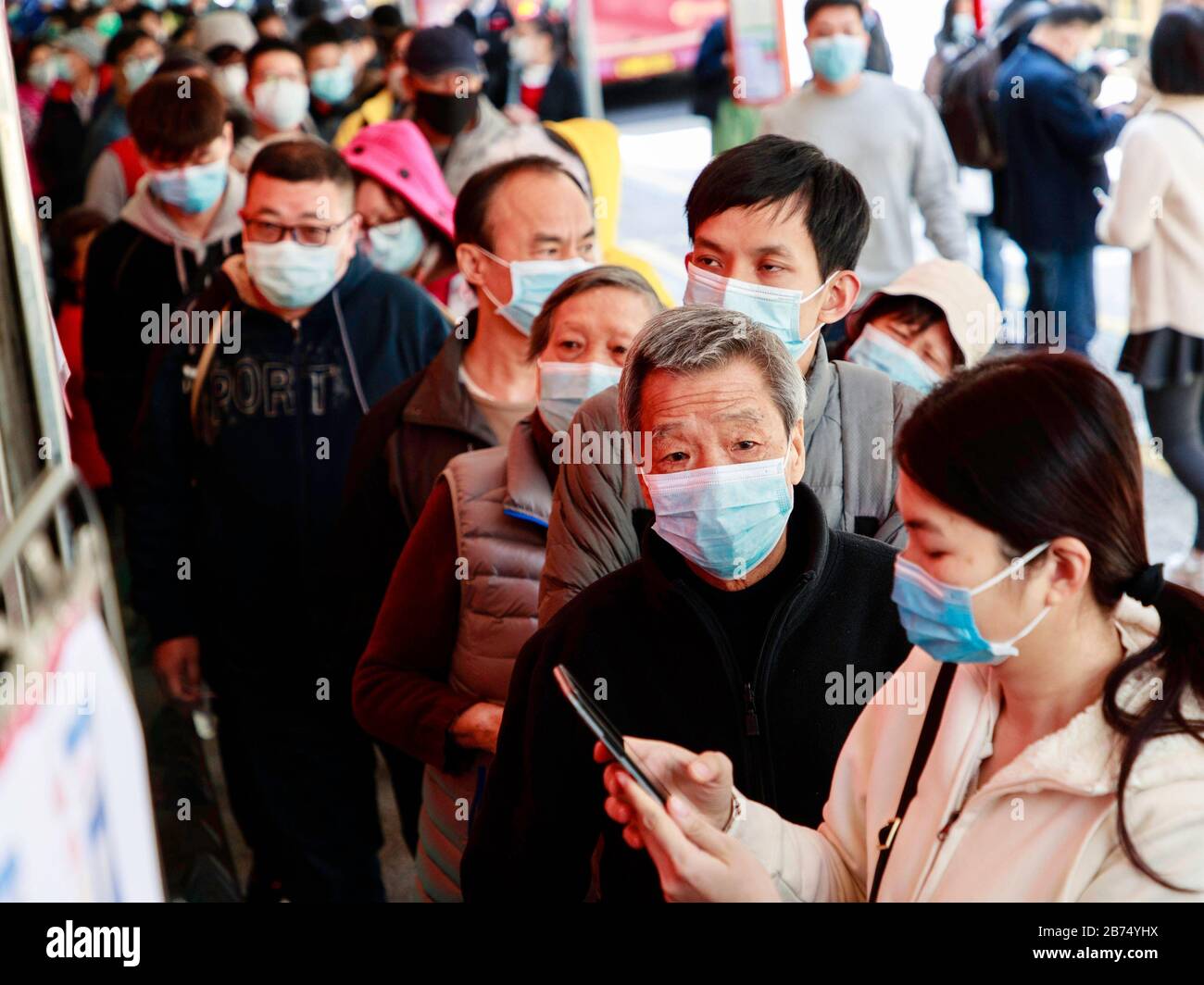 People line up for surgical mask. There is a citywide shortage of ...