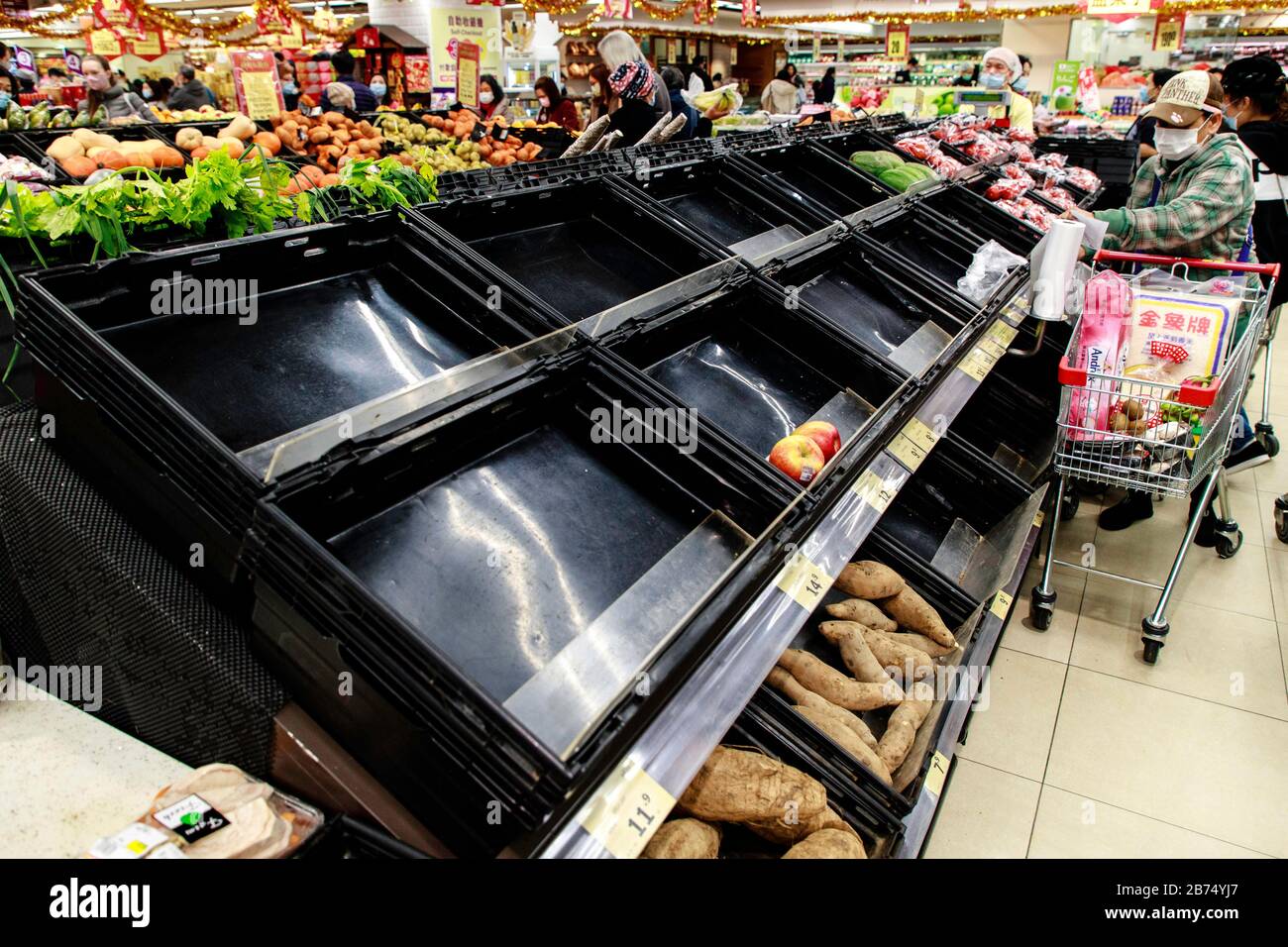 Vegetables were sold out in a supermarket in Hong Kong. People were ...