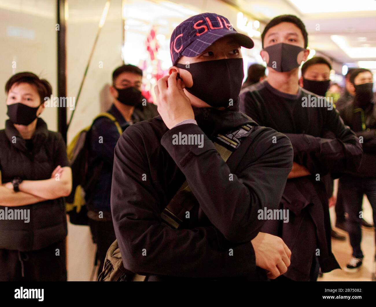 Plain cloth police dress in black bloc stand by as Protesters shout ...