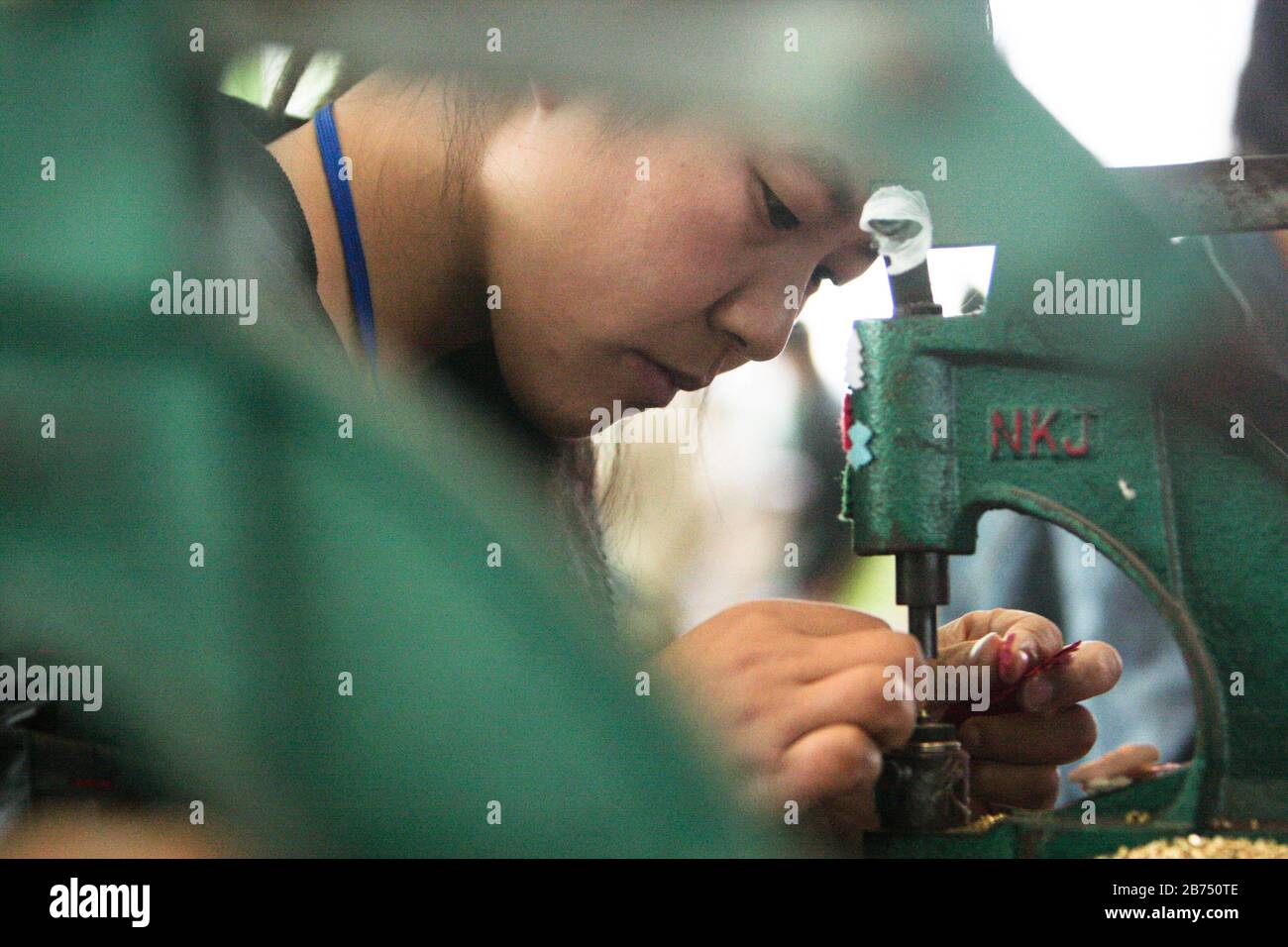 Workers make Remembrance red poppy flower at Good Luck Factory in ...
