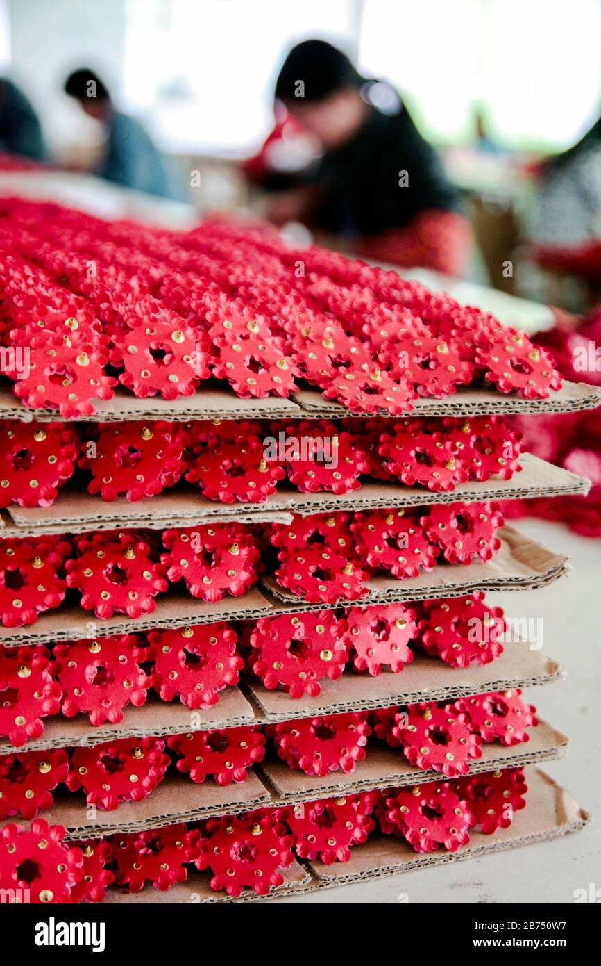 Workers make Remembrance red poppy flower at Good Luck Factory in ...