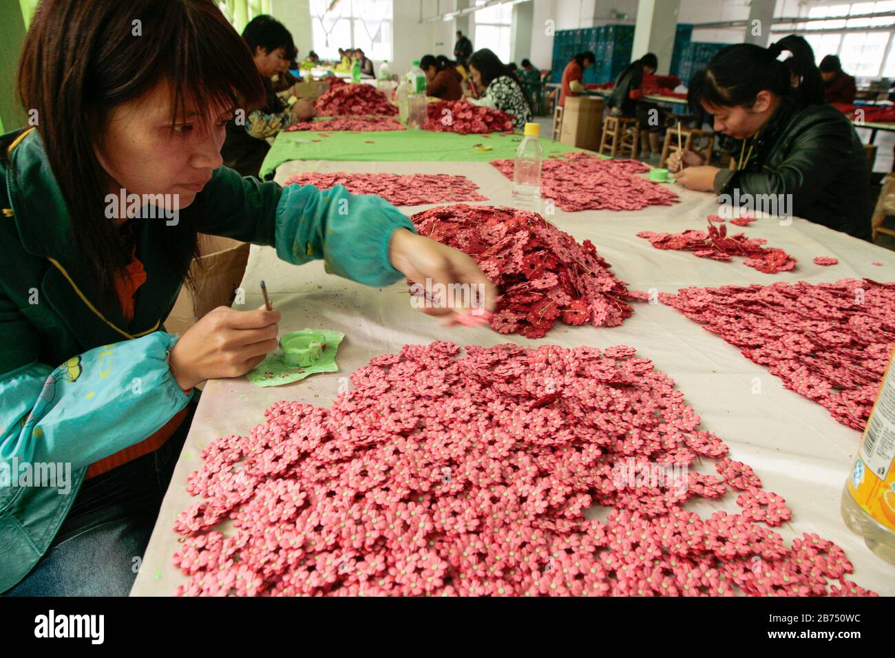 Workers make Remembrance red poppy flower at Good Luck Factory in ...