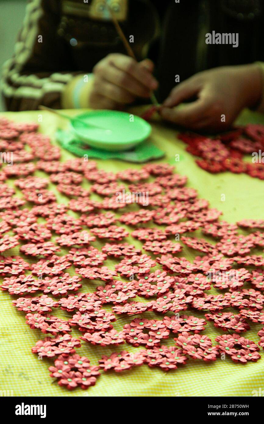 Workers make Remembrance red poppy flower at Good Luck Factory in ...