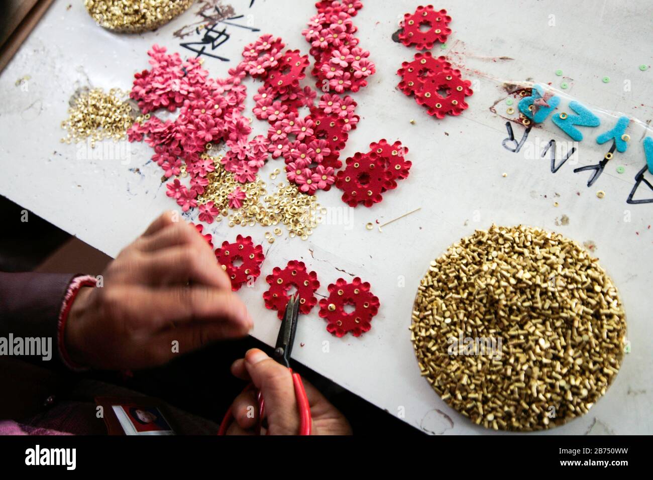 Workers make Remembrance red poppy flower at Good Luck Factory in ...