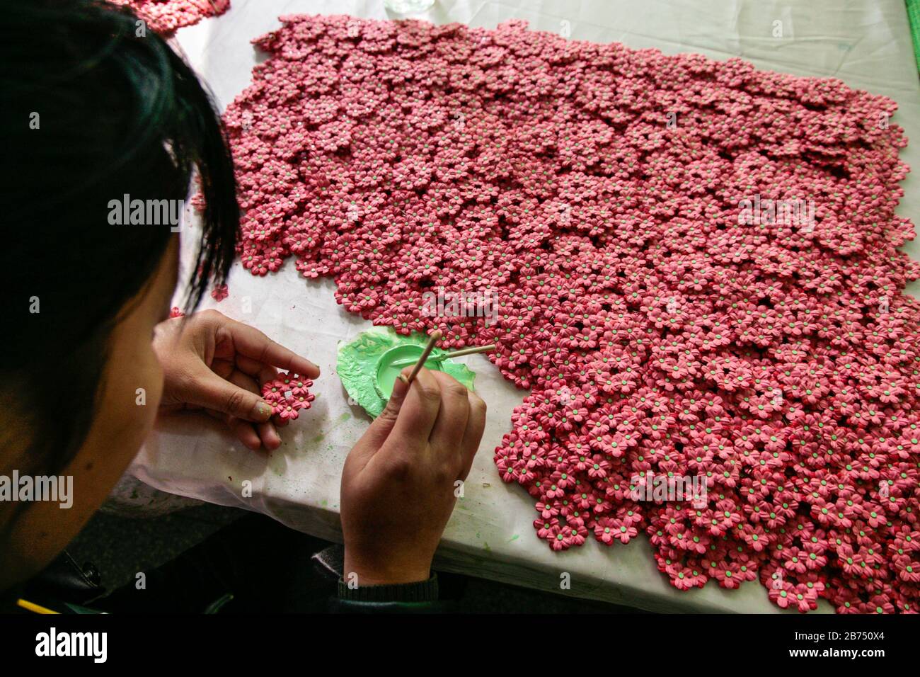 Workers make Remembrance red poppy flower at Good Luck Factory in ...