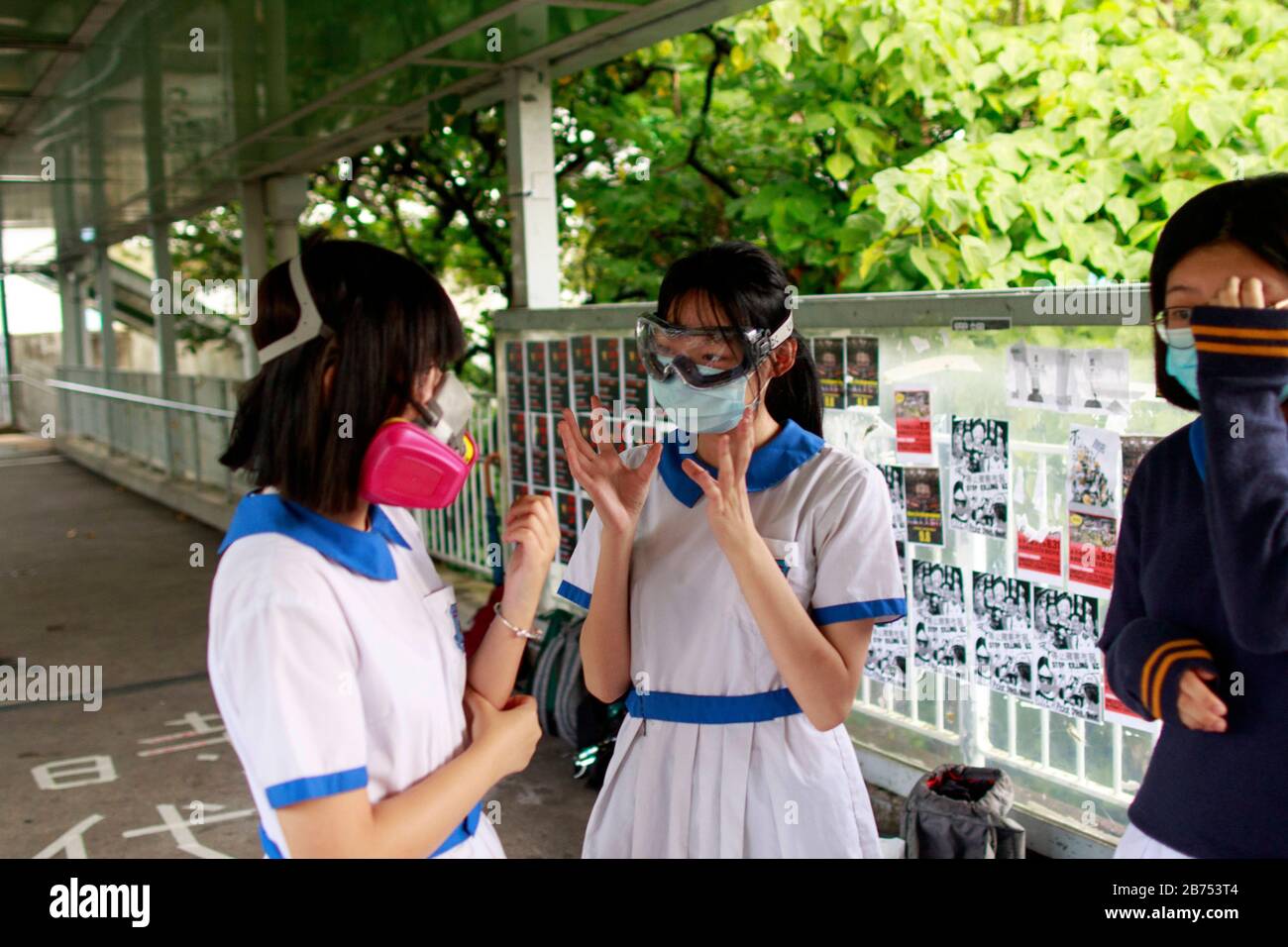 Four secondary schools students form a human chain to support a student ...
