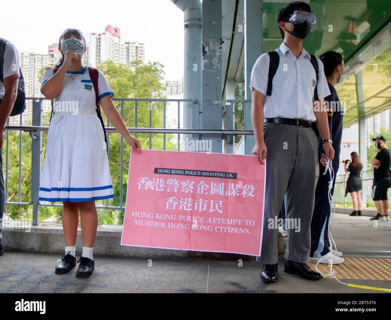 Four secondary schools students form a human chain to support a student ...