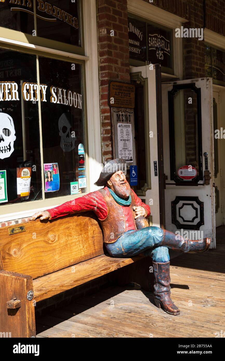Wood carved cowboy, Saloon Sam, on the porch of the River City Saloon ...