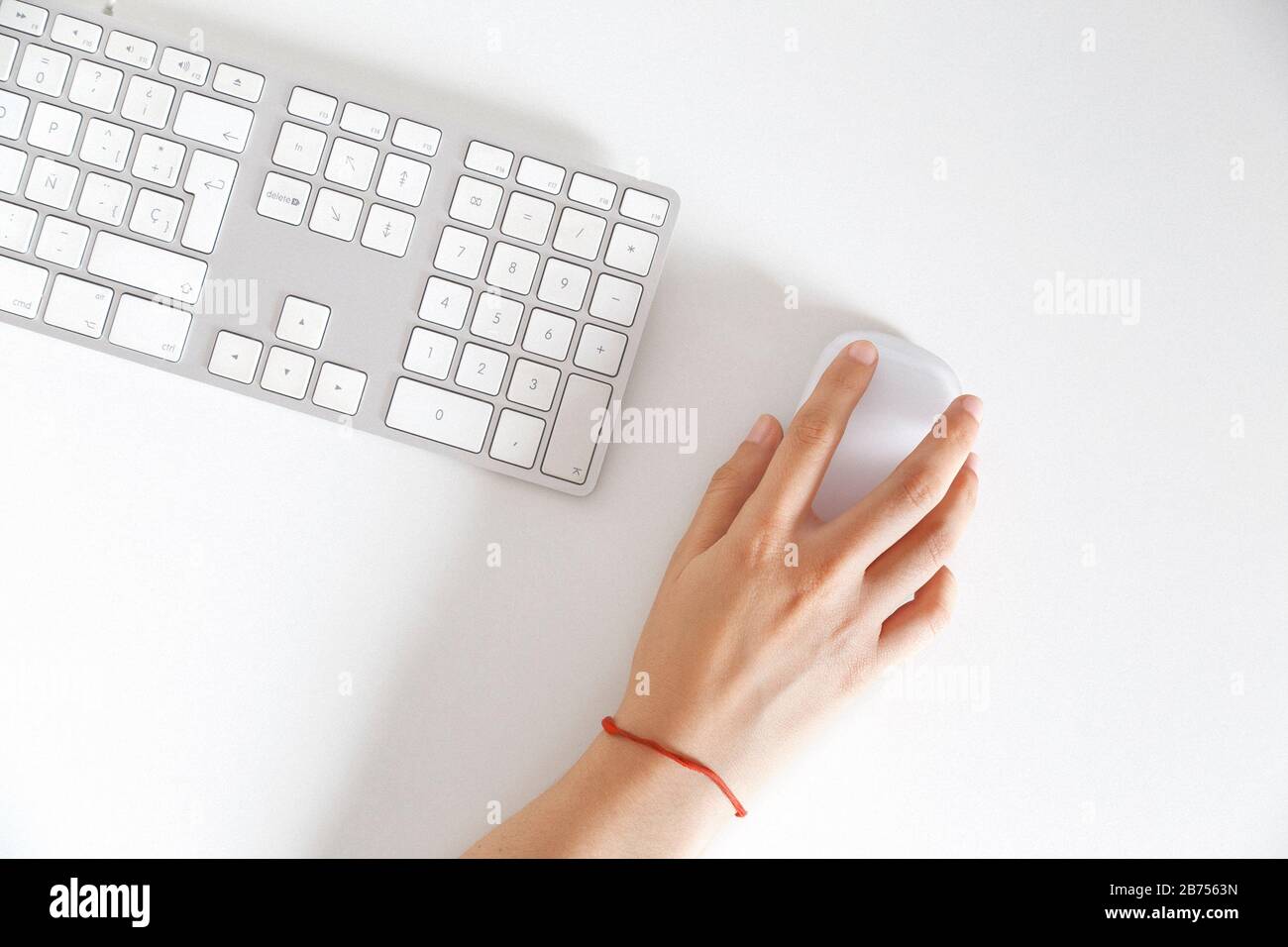 Office desk table with keyboard,hand holding mouse Top view Stock Photo ...