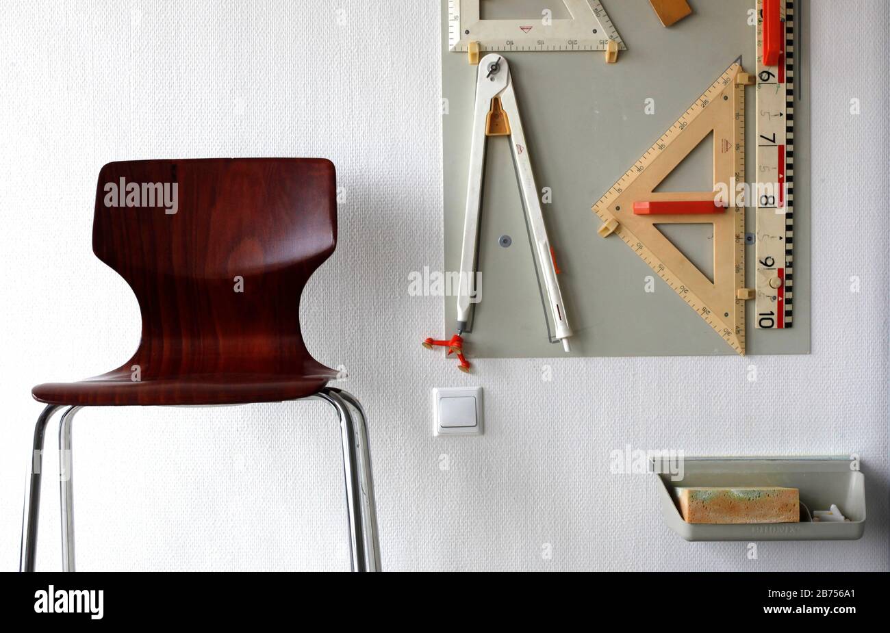 The symbolic image of a school, a compass, rulers and a triangle are ...