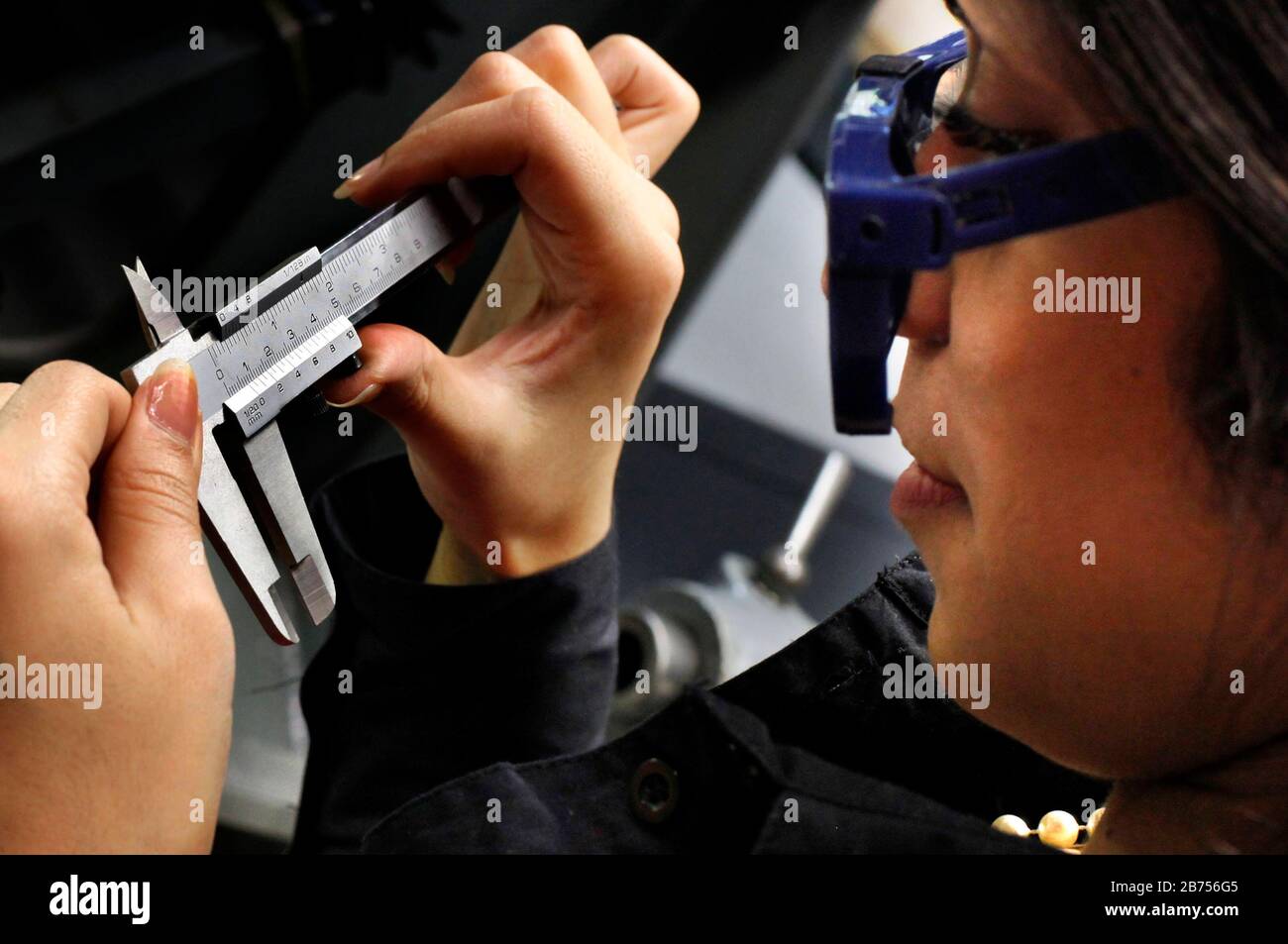 Symbol picture training, one trainee works with a calliper gauge ...