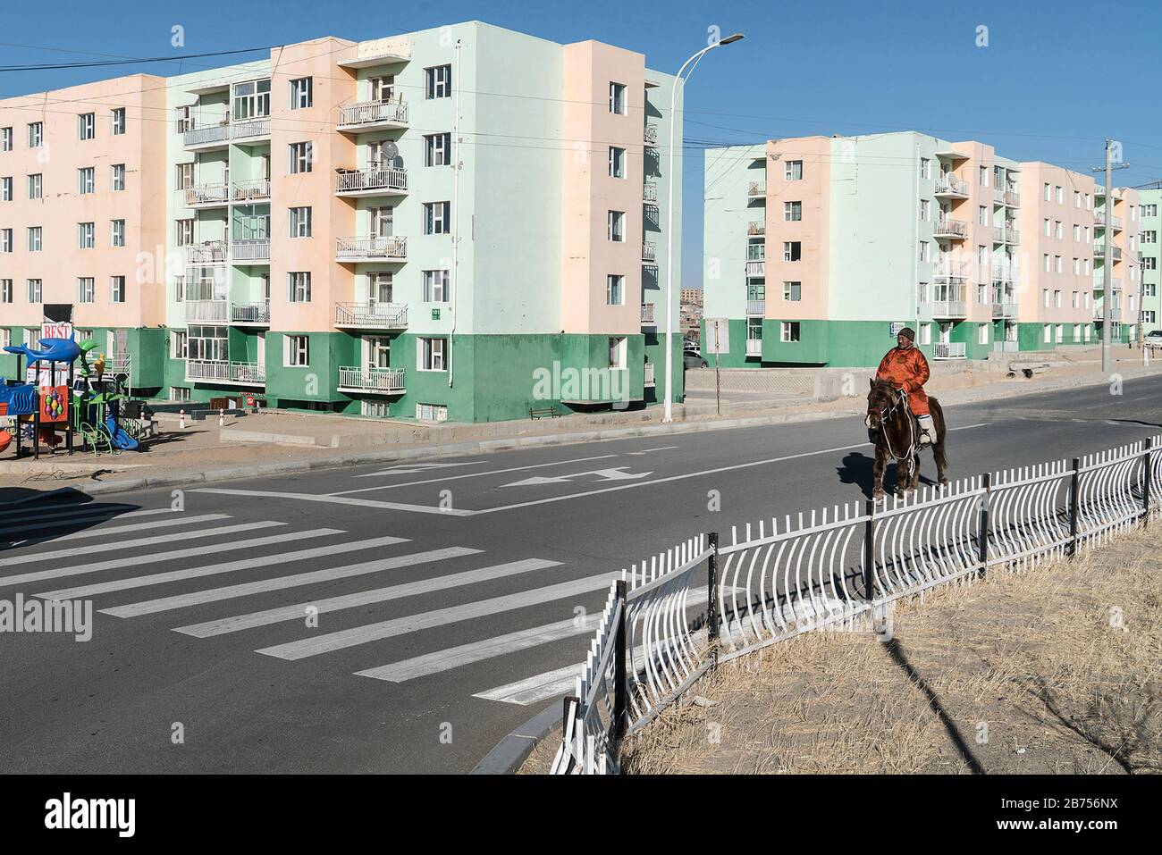 A man rides his horse to the provincial town of Sainshand. [automated ...