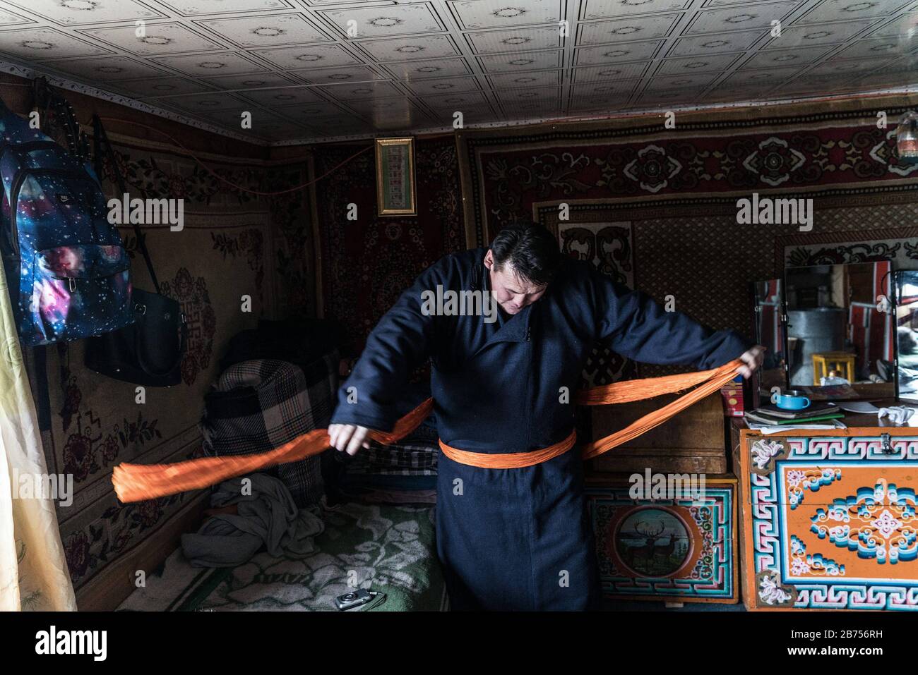 A man attracts a Deel. The Deel is a traditional Mongolian robe ...