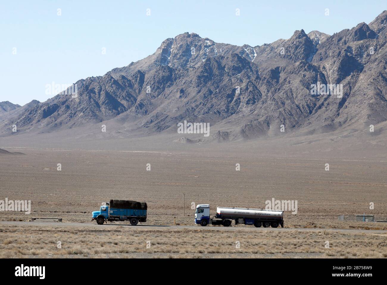 An old round bonnet Mercedes truck in front of a new Mercedes truck on ...