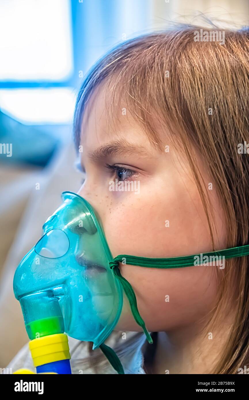 Cute baby girl breathes through nebulizer inhaler Stock Photo - Alamy