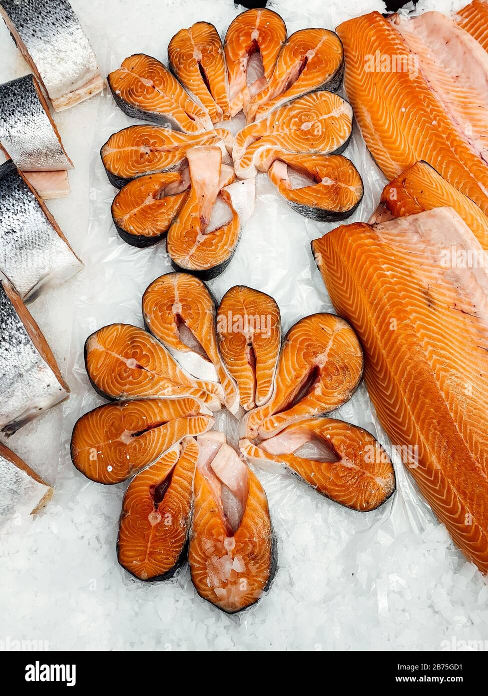 fresh raw red fish lies on the ice as a background for food Stock Photo ...