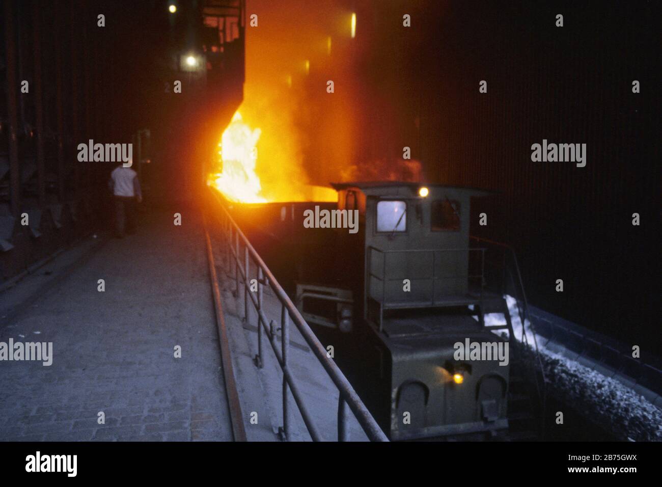 Burning coke falls from the coke oven into the fire engine at the ...