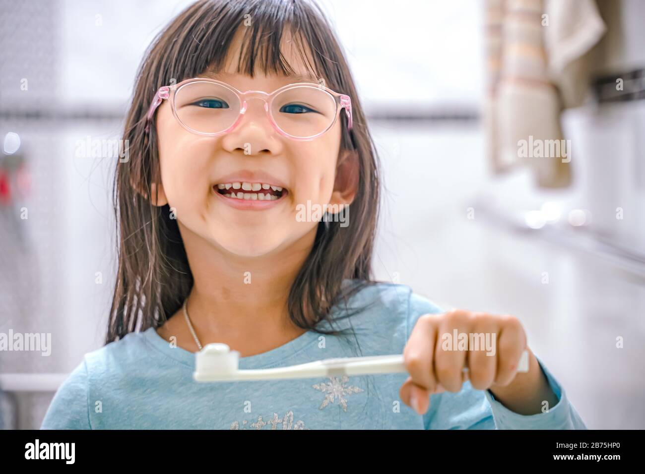 Little girl brushing teeth in bath.dental hygiene. happy little girl ...