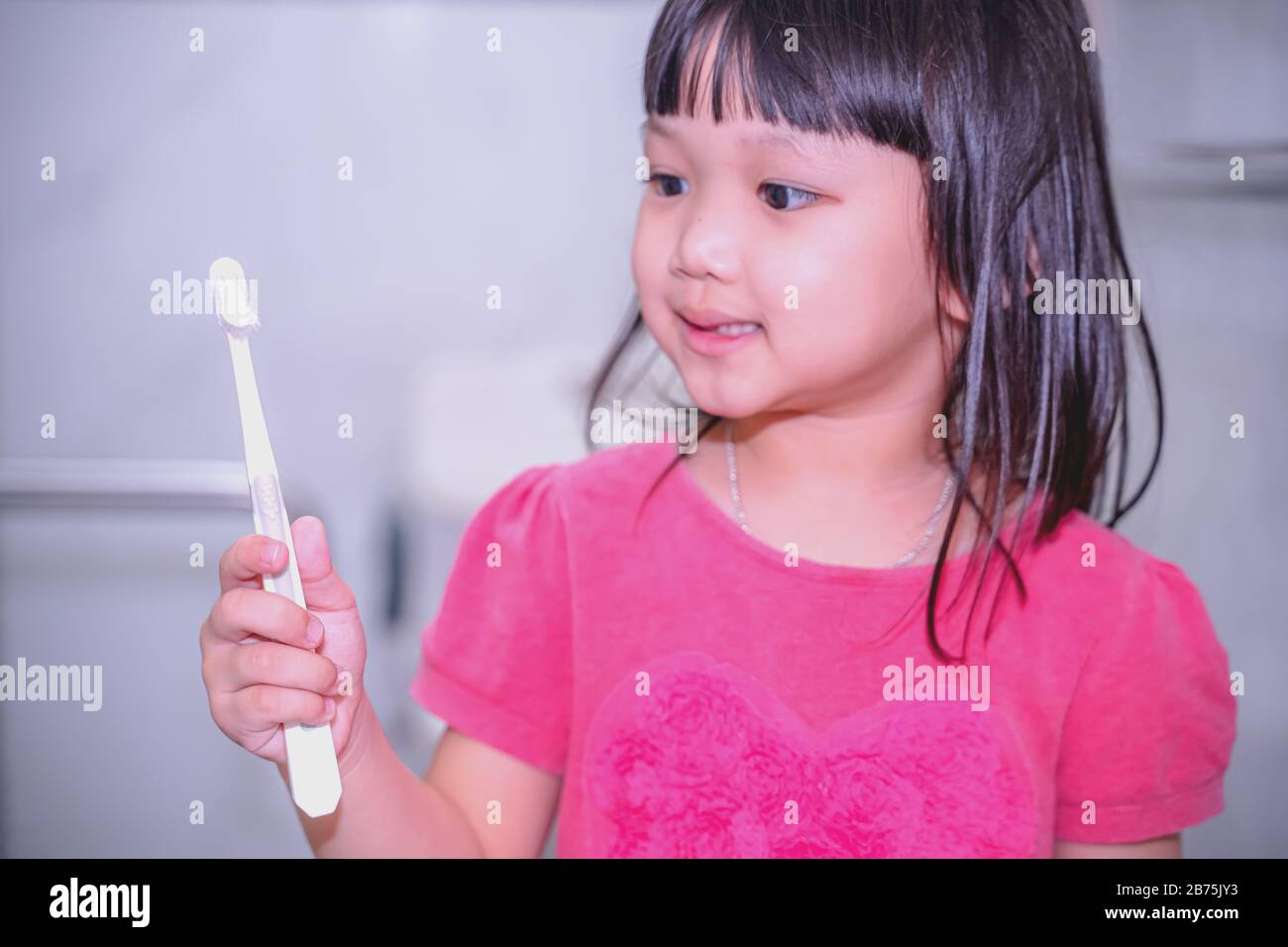 Little girl brushing teeth in bath.dental hygiene. happy little girl ...