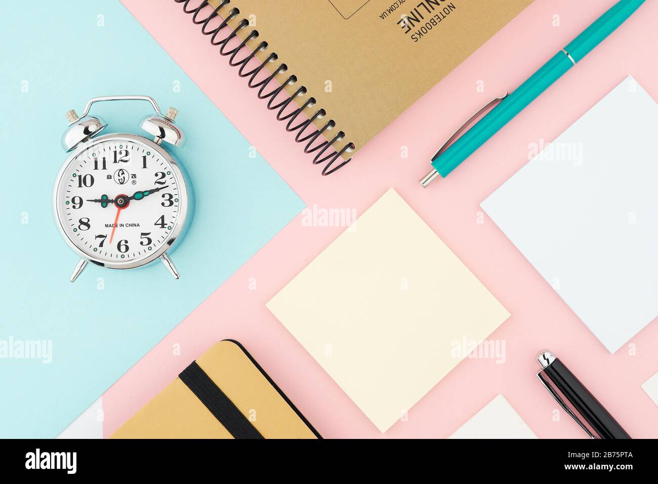 Metal vintage alarm clock with office pen and notes on colorful paper ...