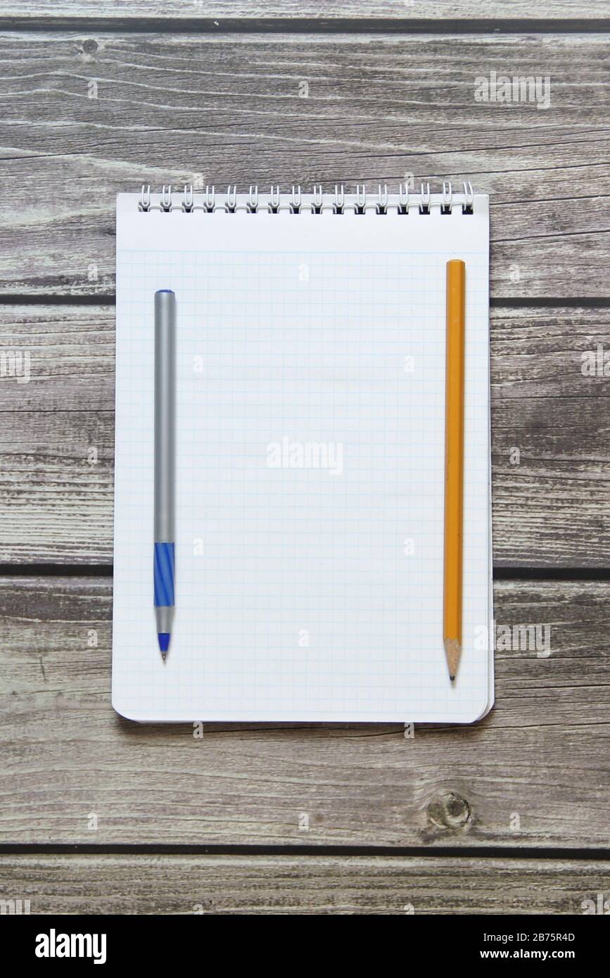 Notepad with a blank white sheet in a checker paper with ball pen and ...