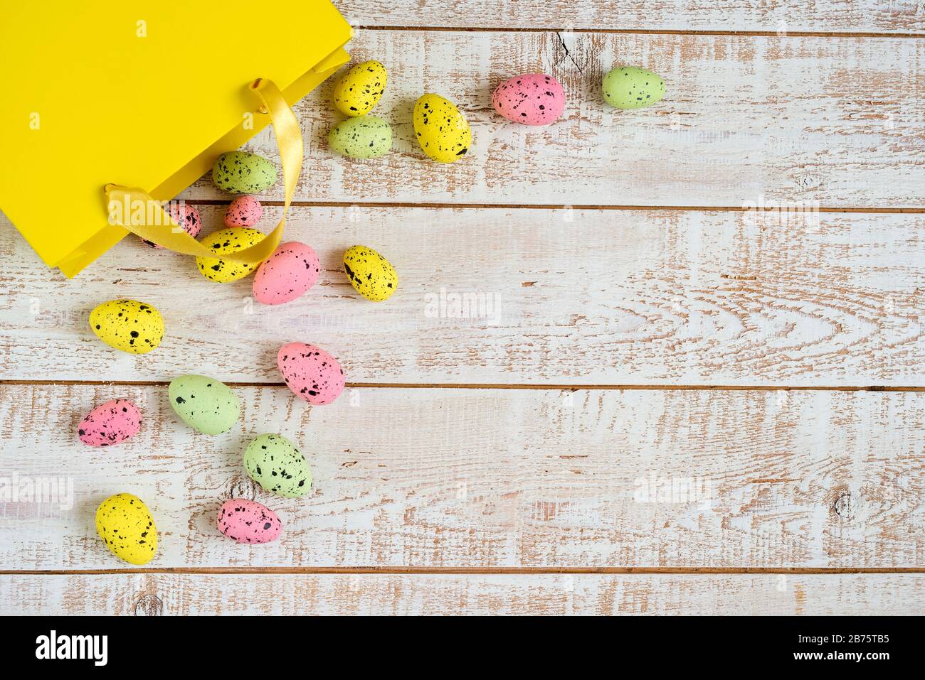 Easter eggs over white wooden vintage table - top view, copy space ...