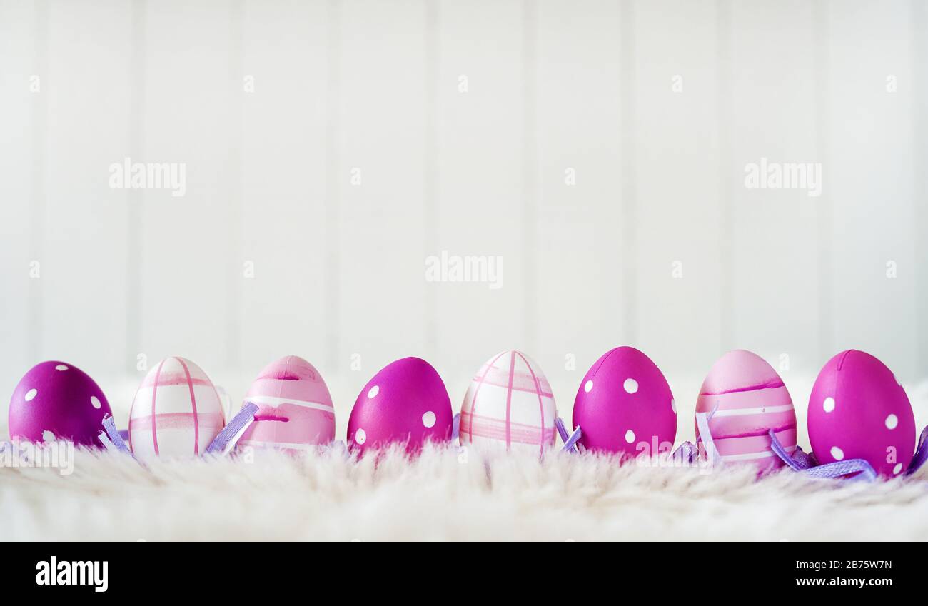 Easter eggs over white striped background - copy space Stock Photo - Alamy