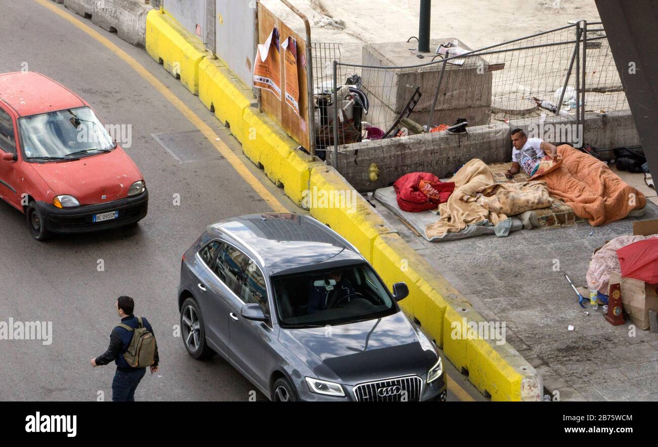 Homeless people are lying on mattresses at the Naples Central Station ...