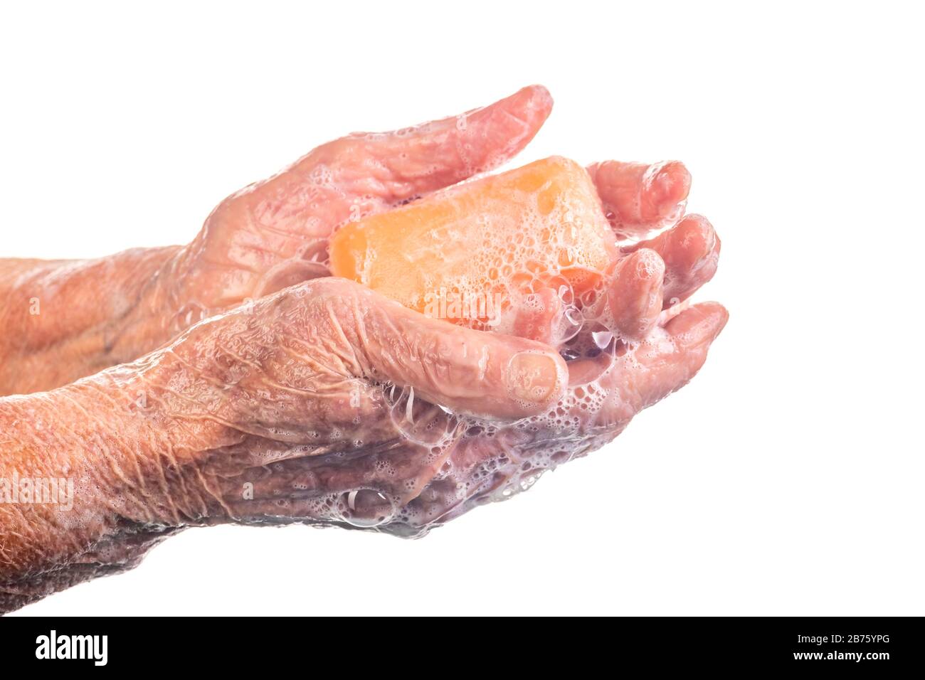 Senior woman washing hands using soap on white background, hygiene ...