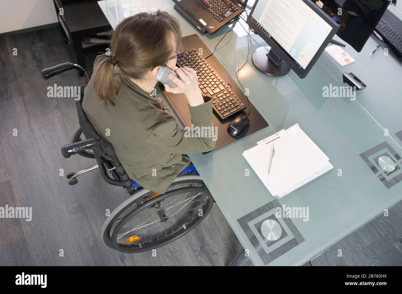 Young disabled woman in wheelchair on 18.01.2017 at her computer ...