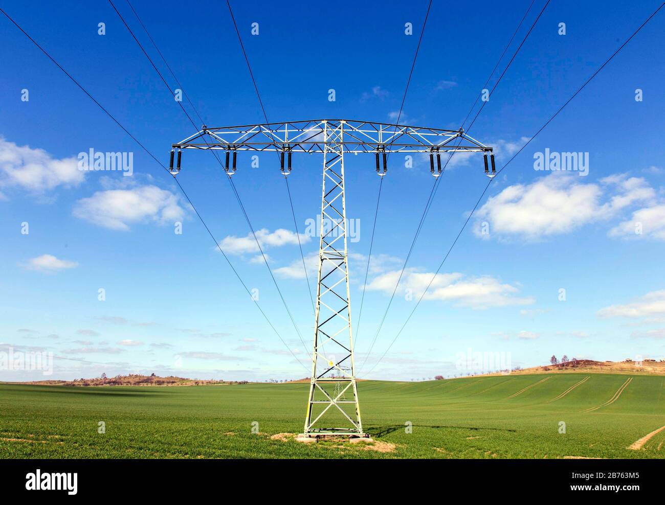 Power poles and power lines of a power line on open field near Thale ...