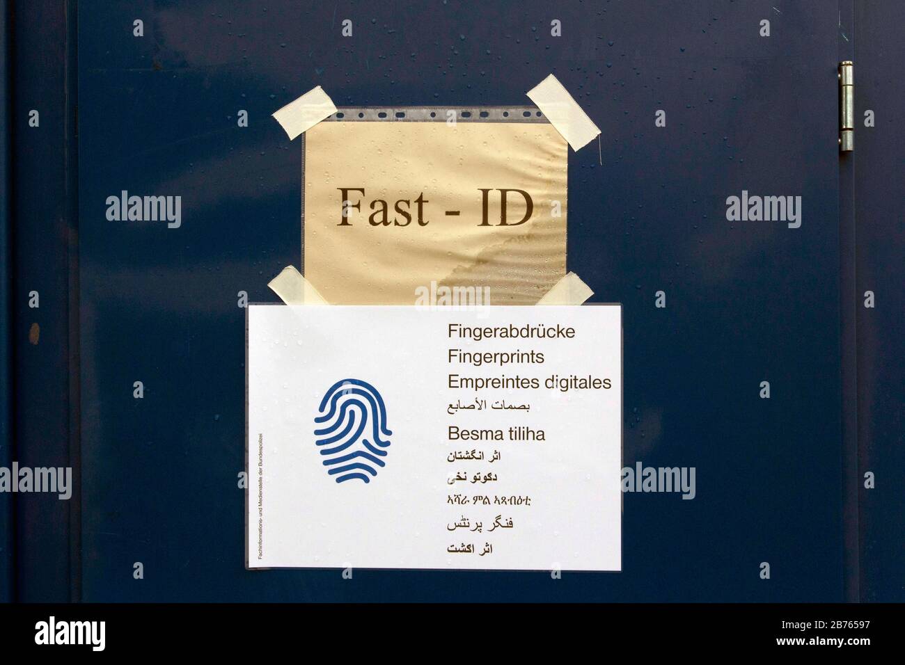 "Fast-ID" and "Fingerprints" is written in different languages on a ...