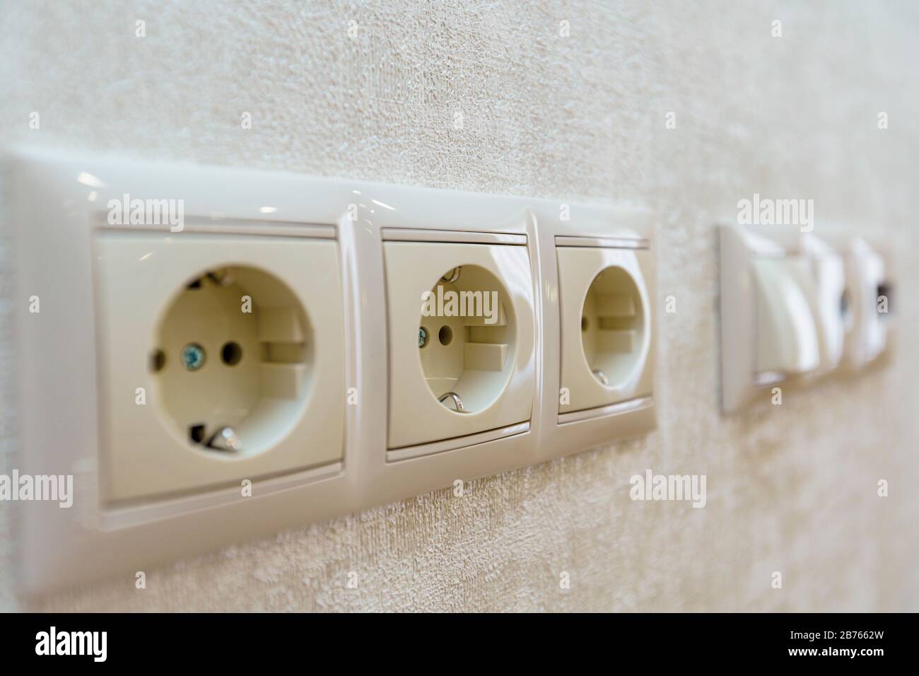 Electrical outlets, connectors for Internet and cable TV on the wall in ...