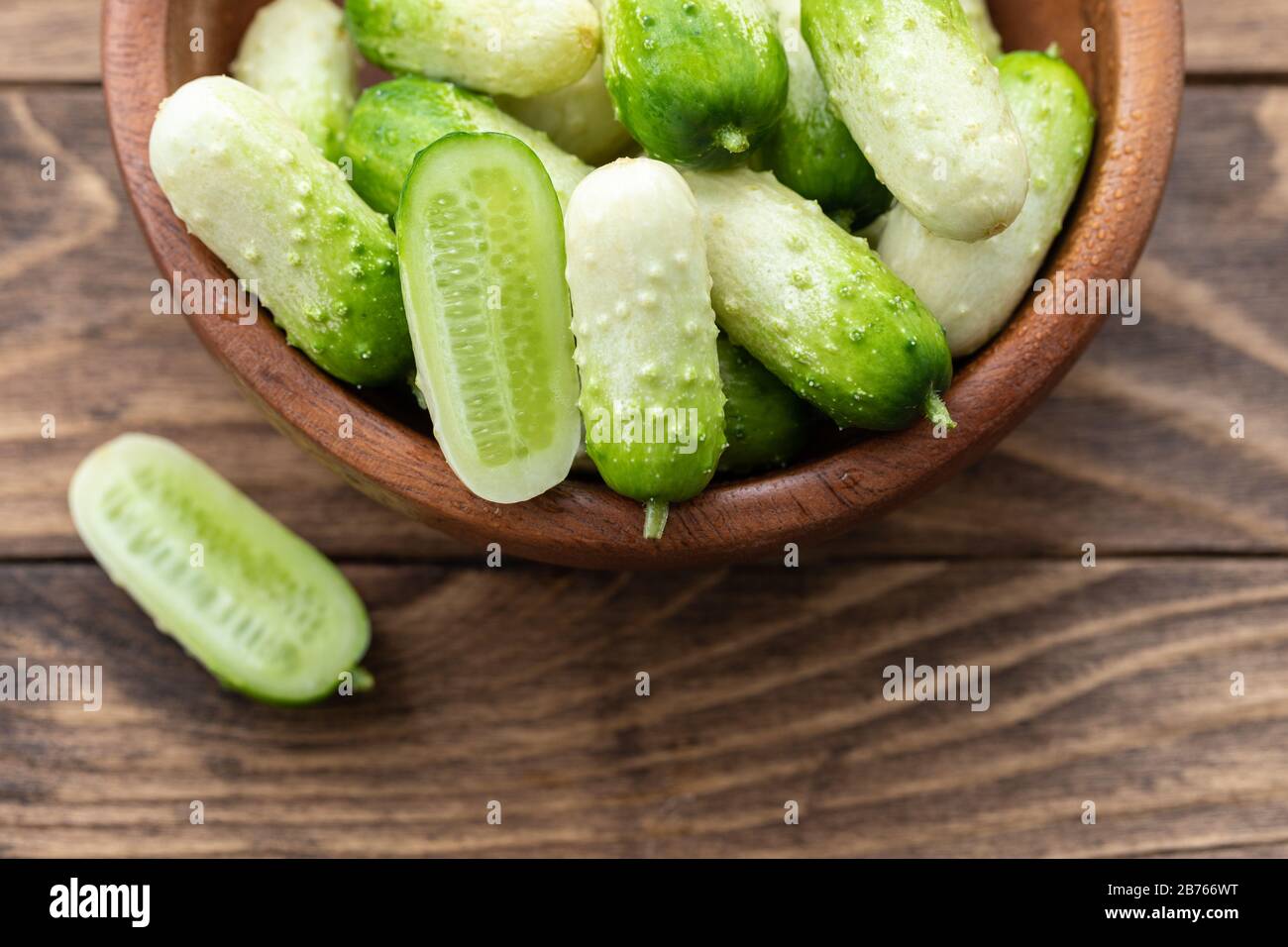 Small fresh snack cocktail Dutch cucumbers Quirk variety on wooden ...