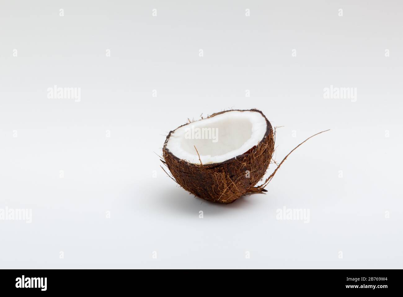Fresh half natural coconut on white background Stock Photo - Alamy