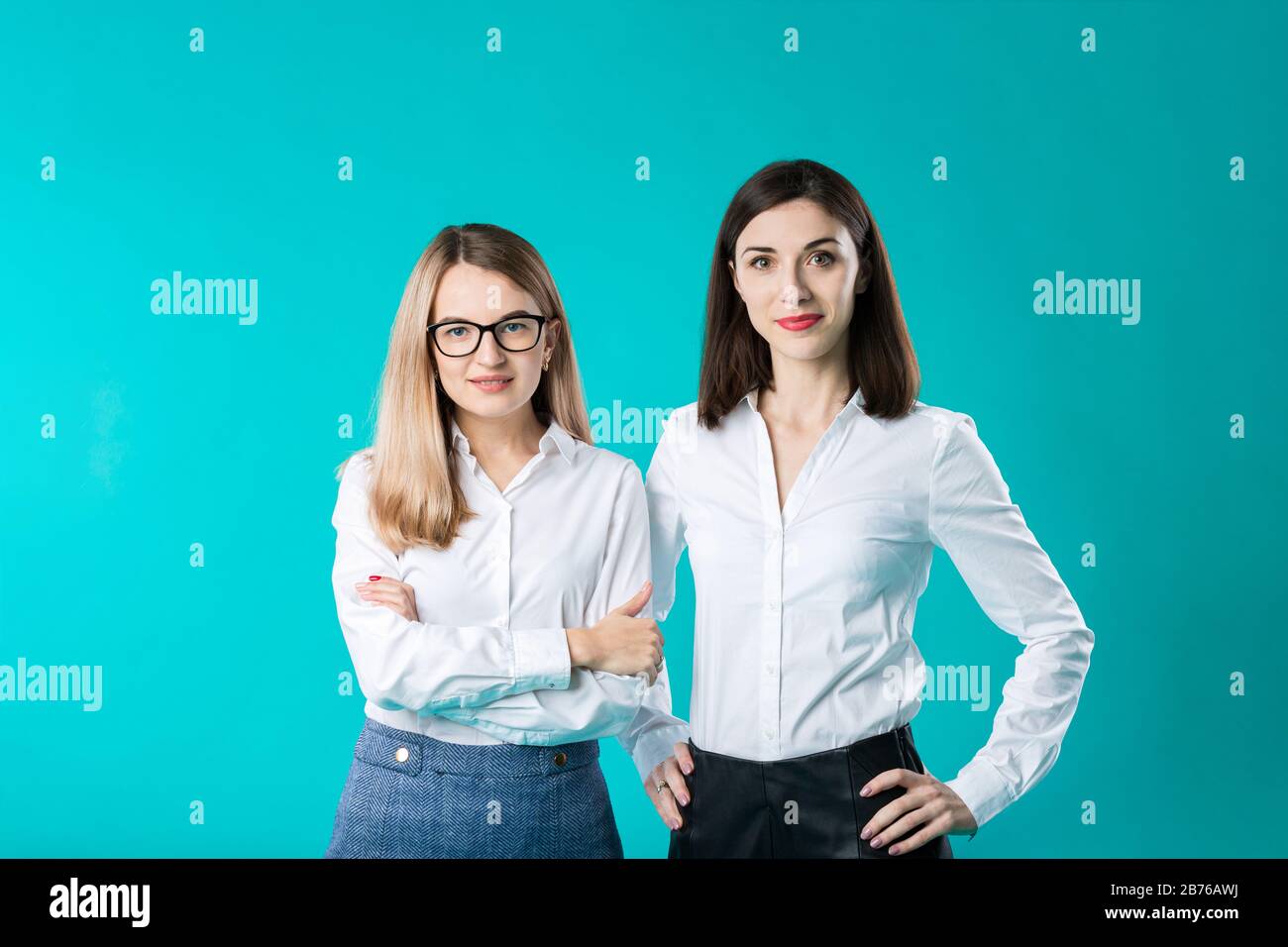 The theme is a female team. Portrait of two young caucasian business ...