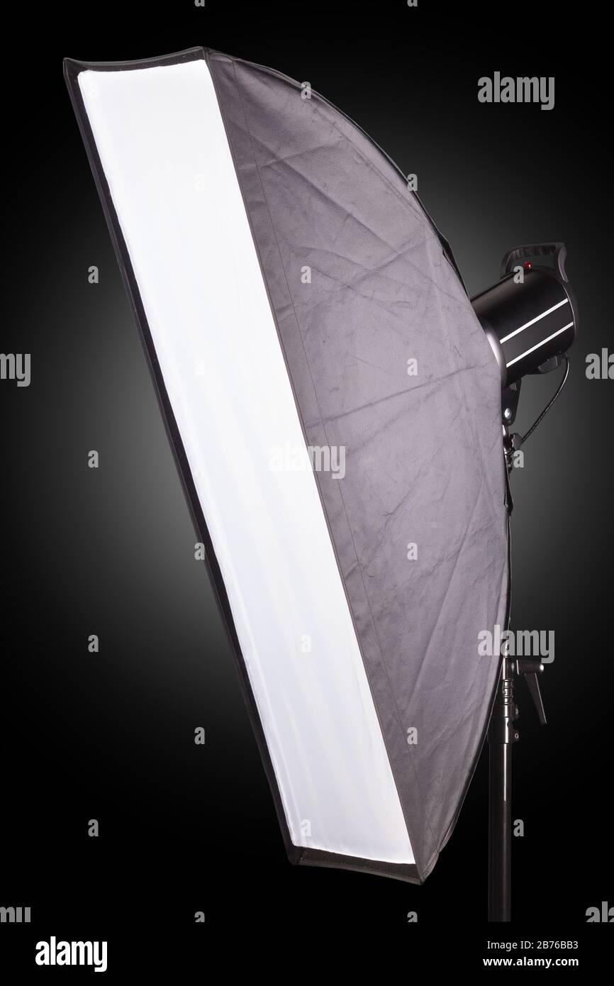 Photography studio flash with softbox isolated on black background with ...