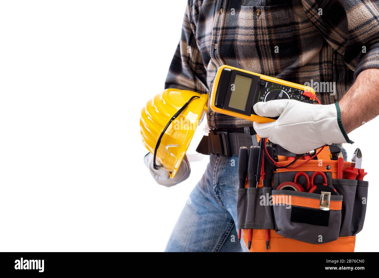 Electrician holds multimeter tester in hand, helmet with protective ...