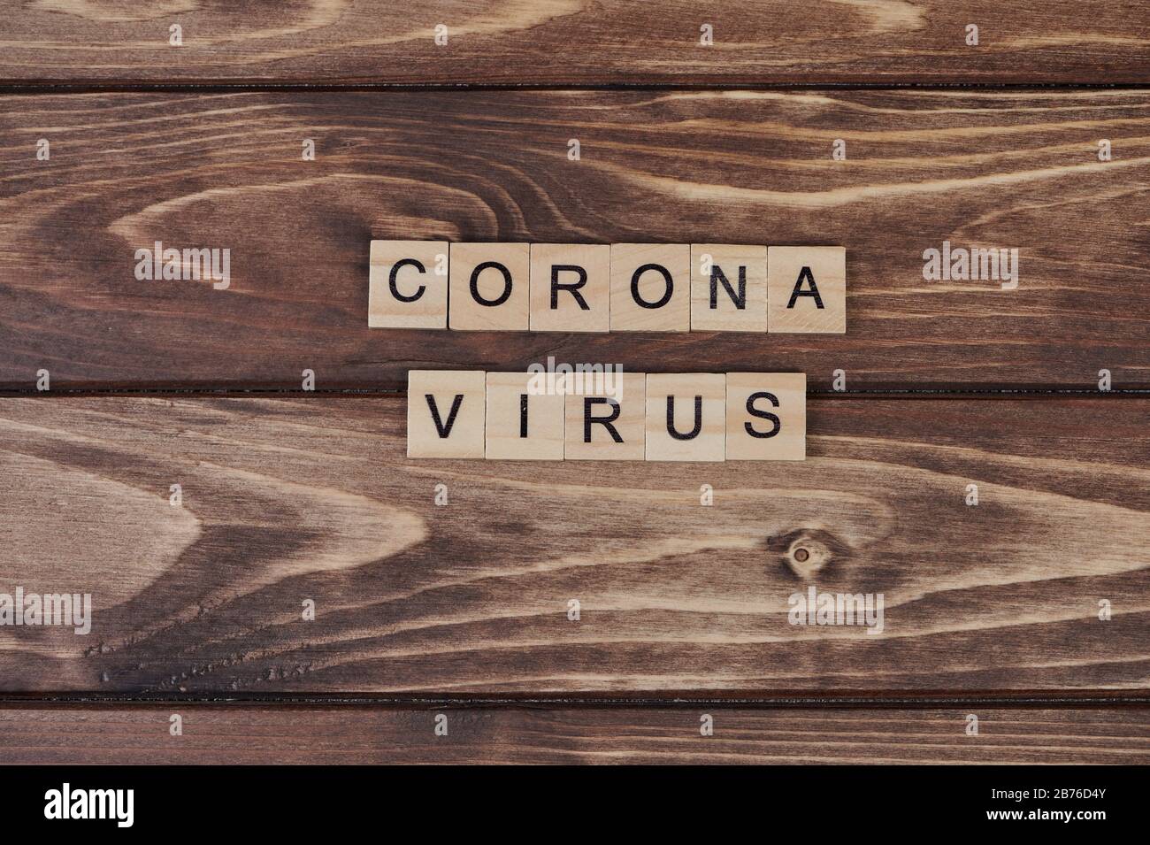 the word Coronavirus, laid with wooden capital letters on wooden ...