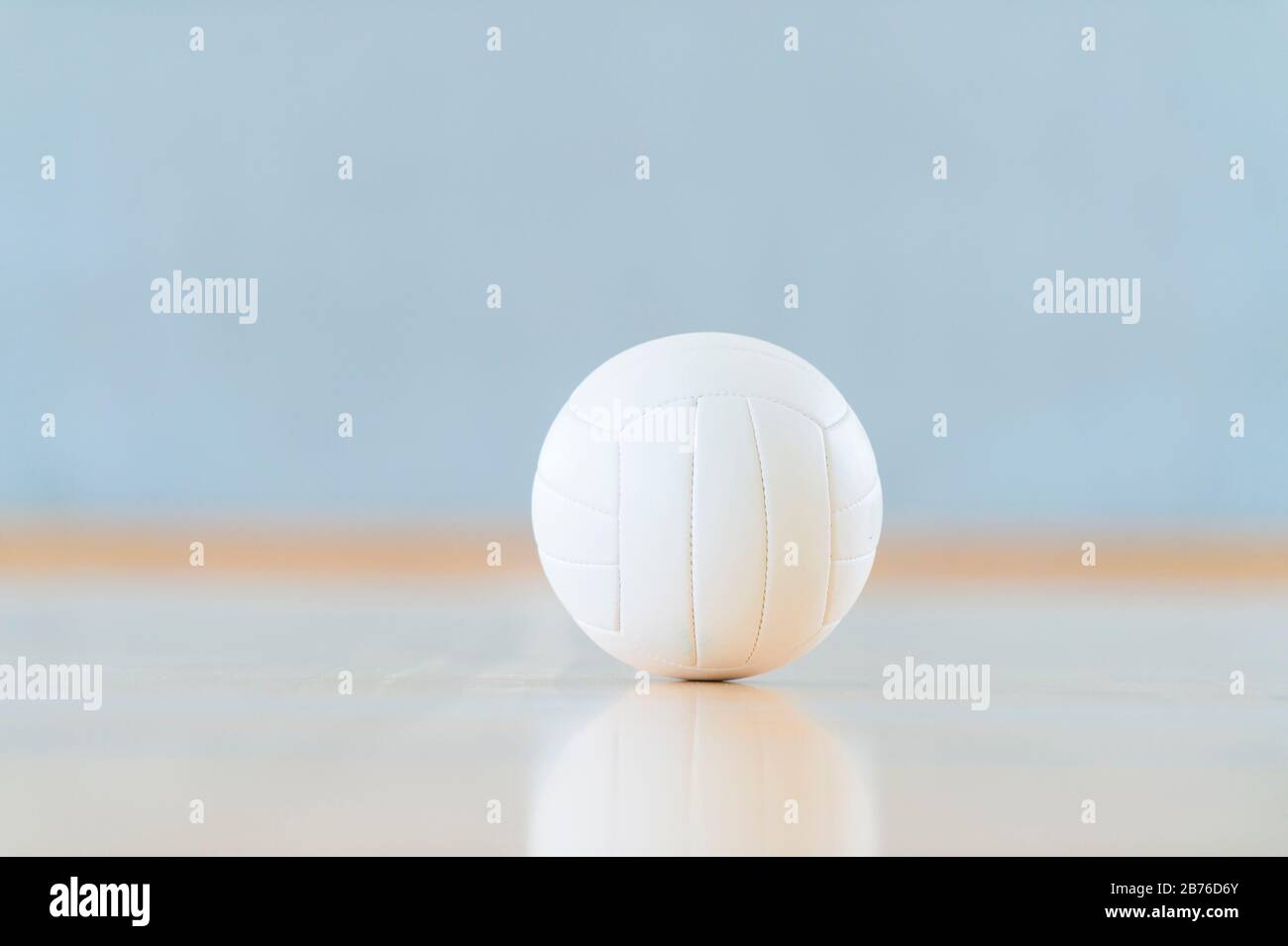 A volleyball and reflection on a wooden floor Stock Photo - Alamy