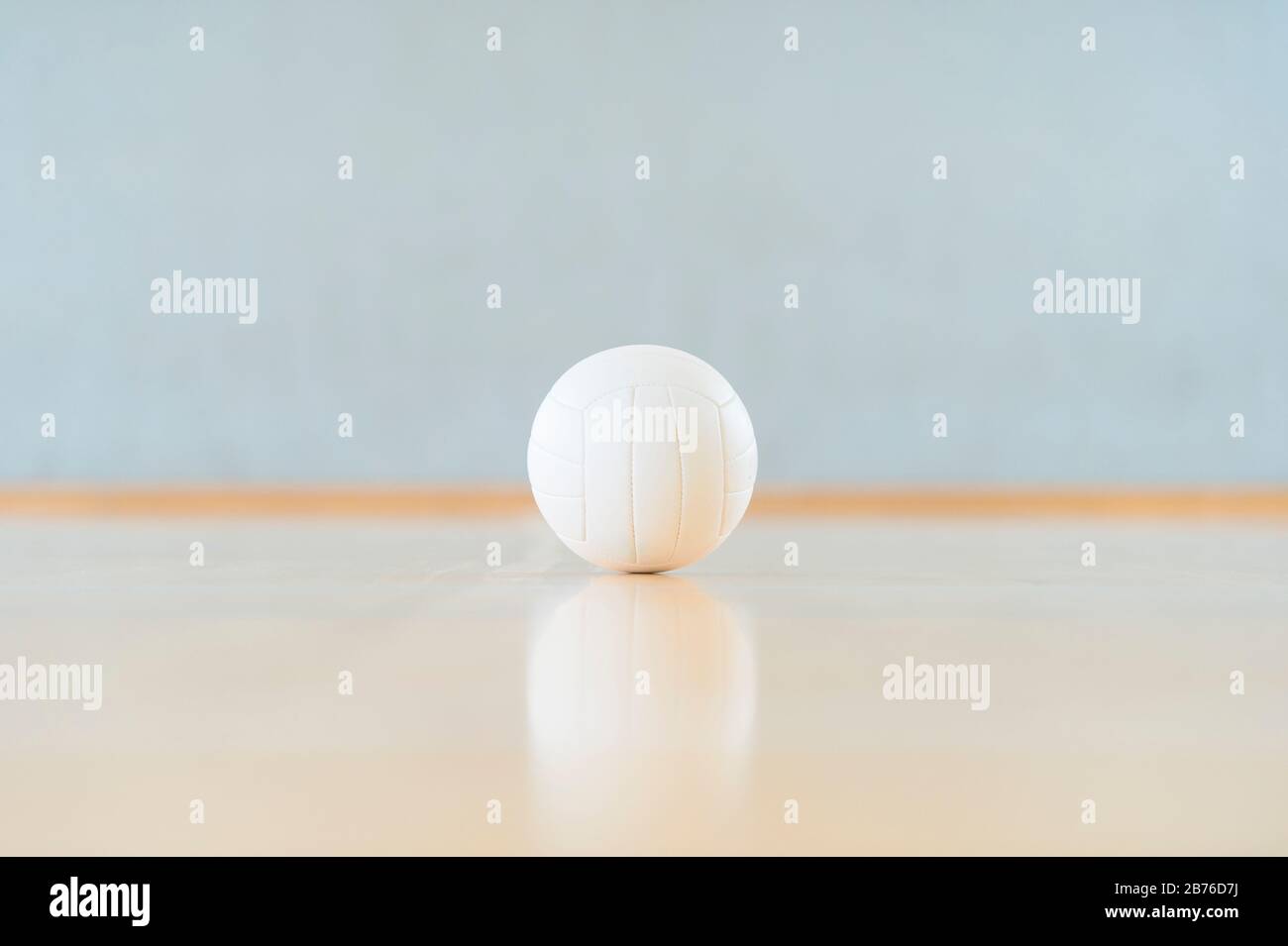 A volleyball and reflection on a wooden floor Stock Photo - Alamy
