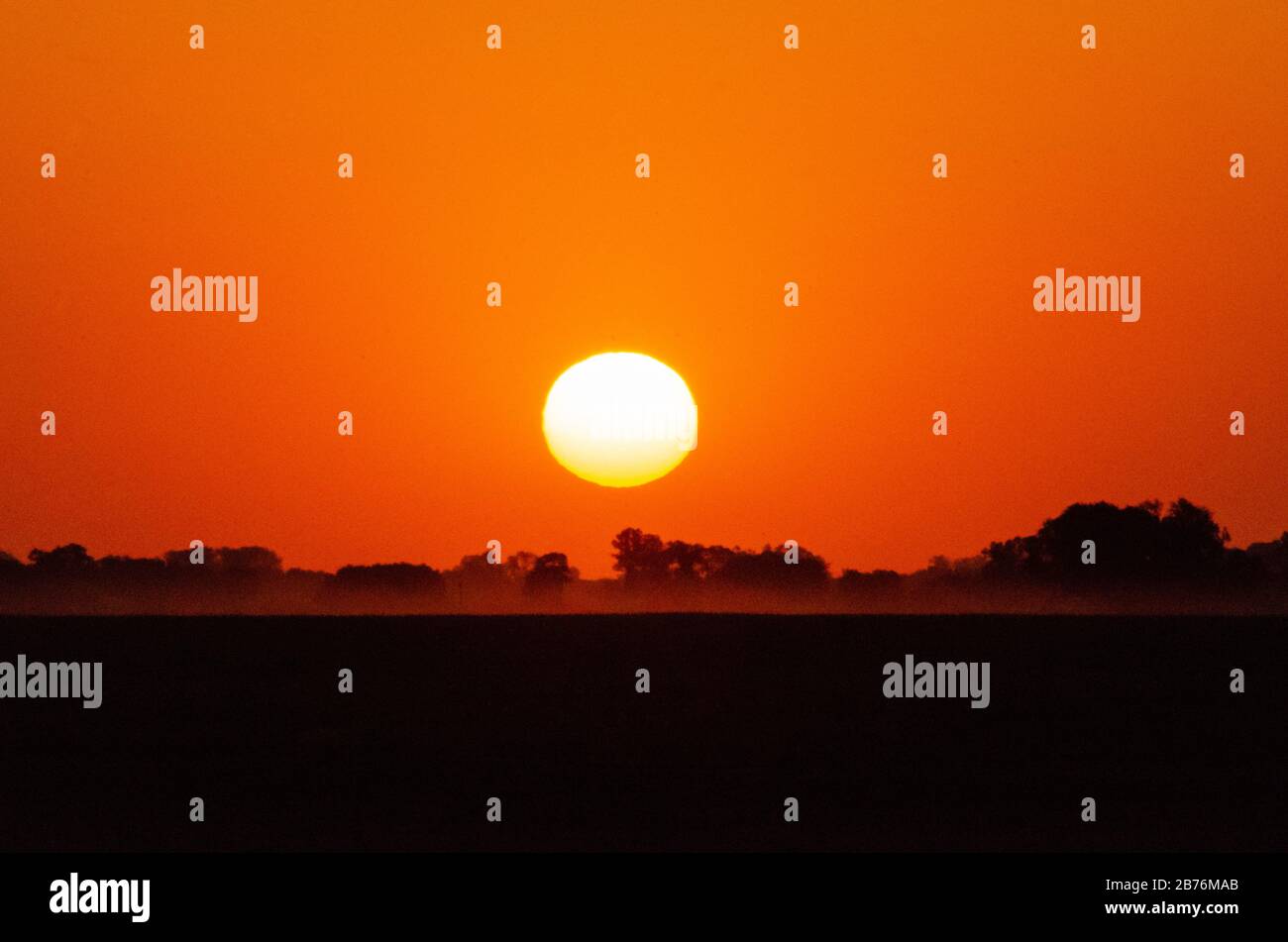 Sunset with a well exposed sun and an overexposed downside, and a dust ...