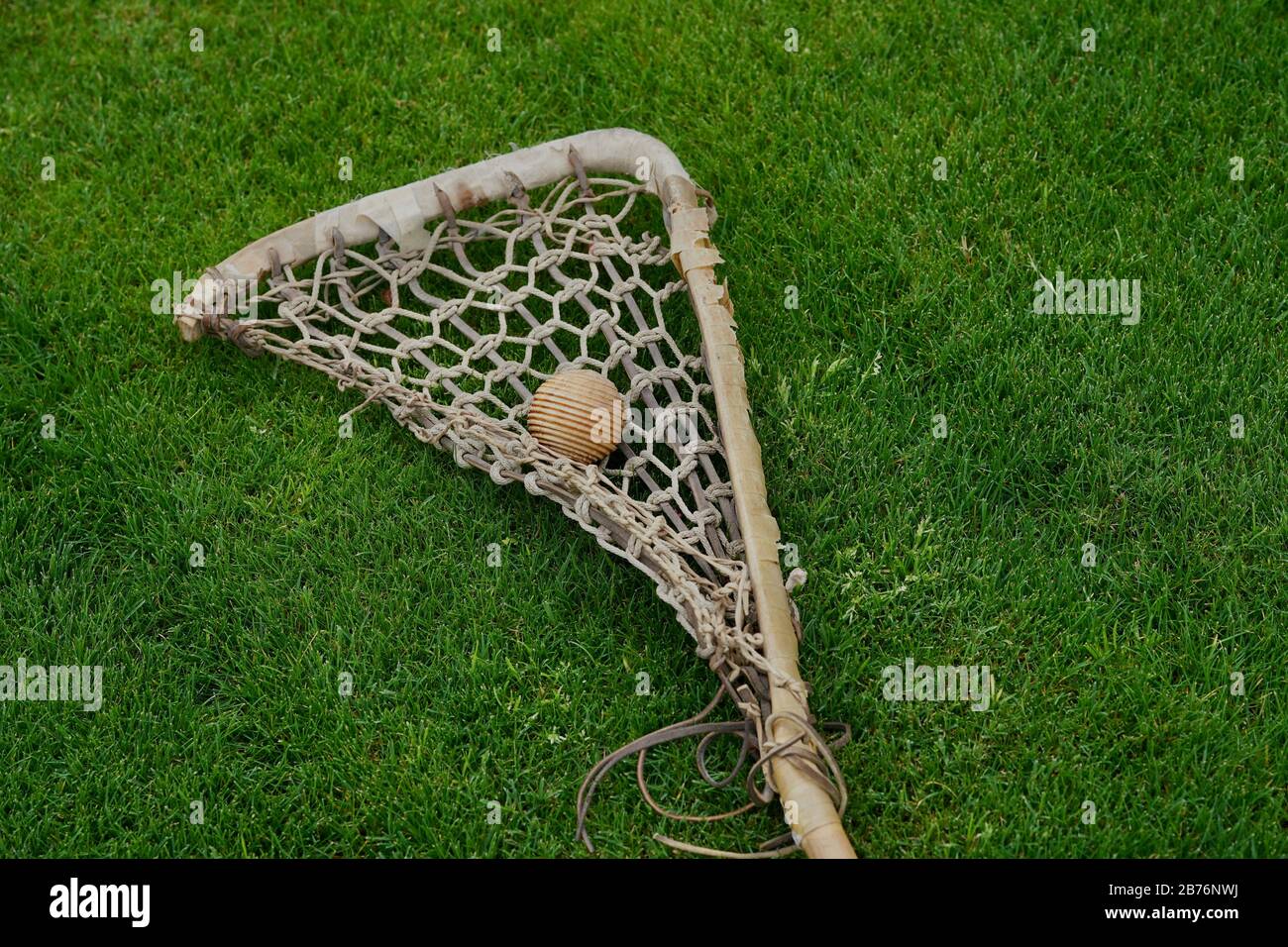 An old wooden lacrosse stick with a wood ball Stock Photo - Alamy