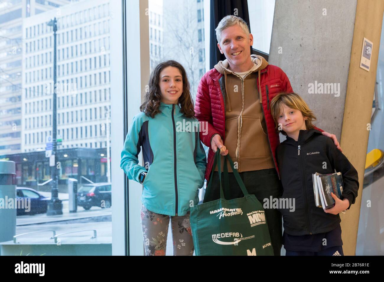 Members of the Cummer family, from Seattle, pose with a stash of books ...