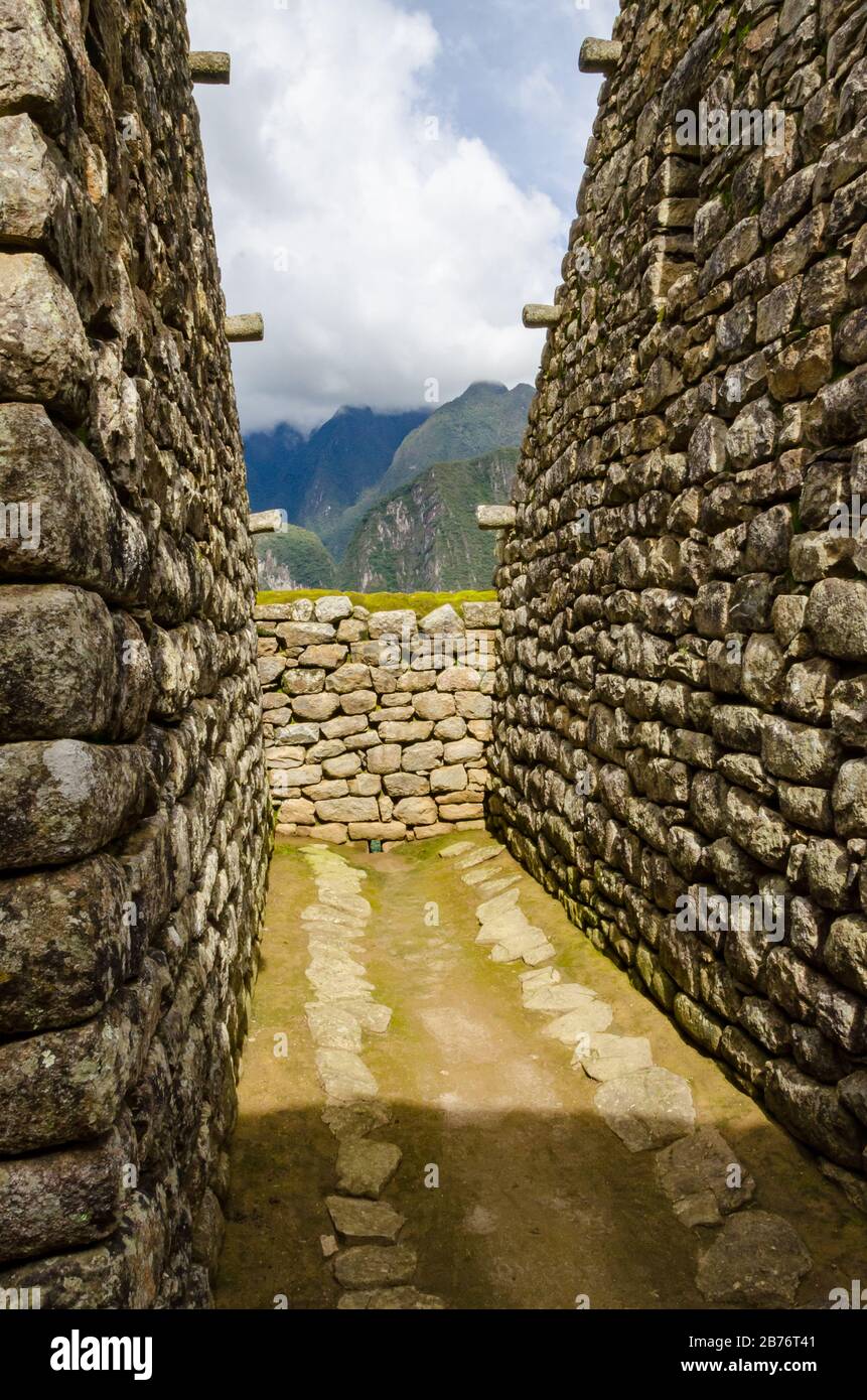 Mountains in between two buildings in Machu Picchu, Peru Stock Photo ...