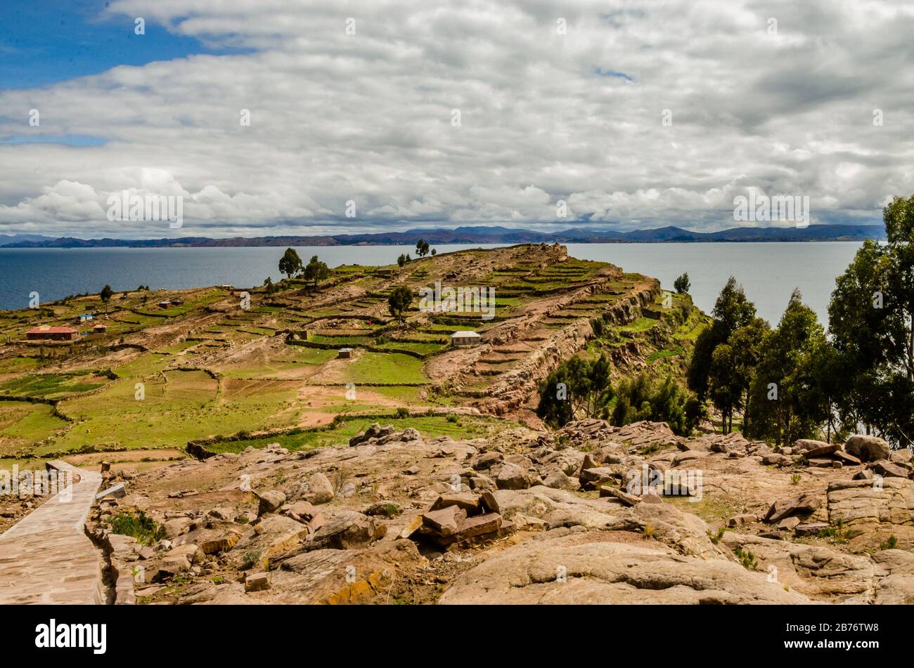 Landscape of the Taquile Island with a stone road, houses and Titikaka ...