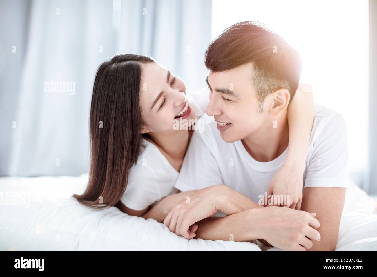 Loving couple on the bed in the bedroom Stock Photo - Alamy