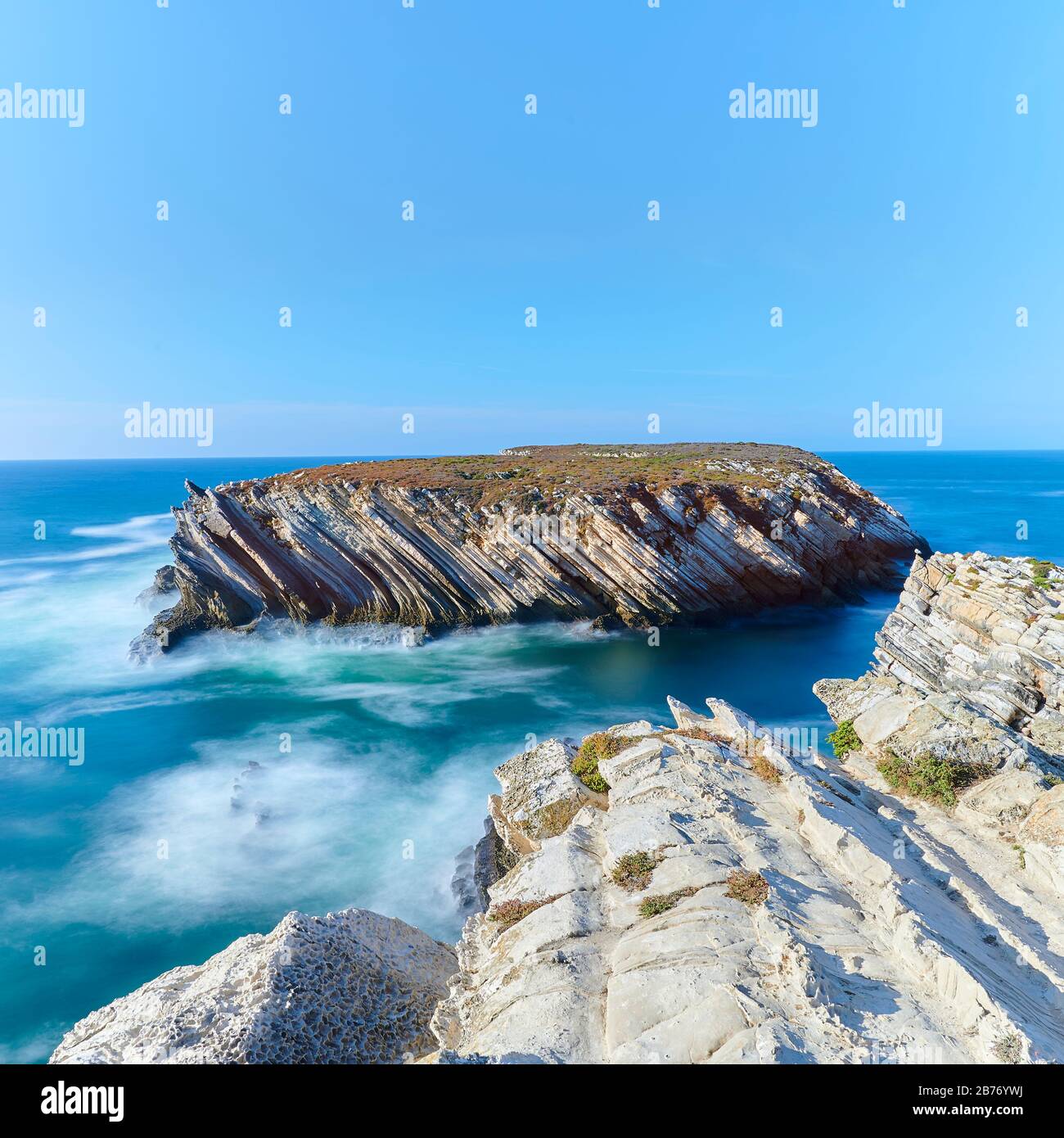Small rock island near the shore long exposure Stock Photo - Alamy
