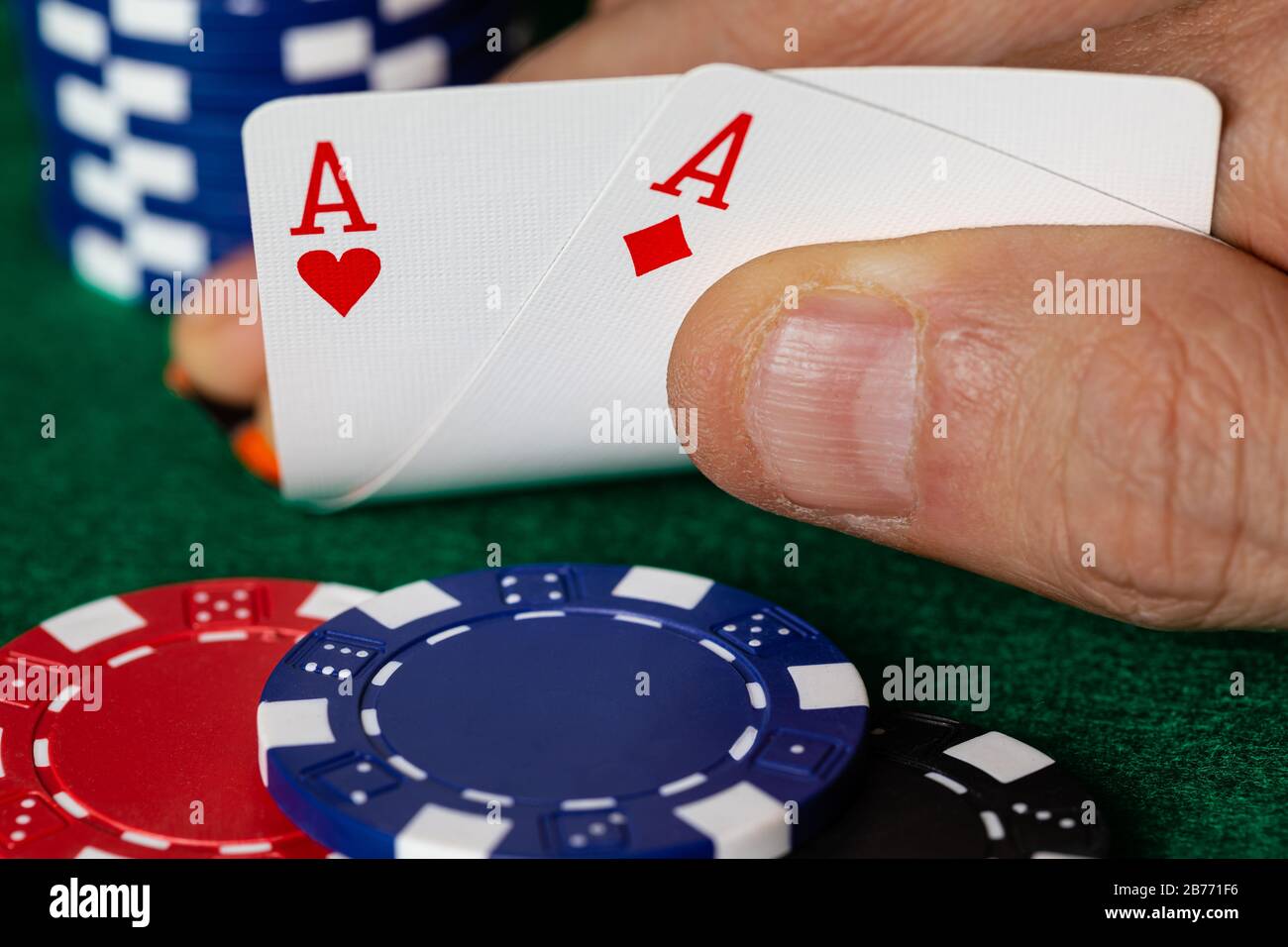 A male Caucasian hand Showing a Pair of Aces in the hole, Hearts and ...