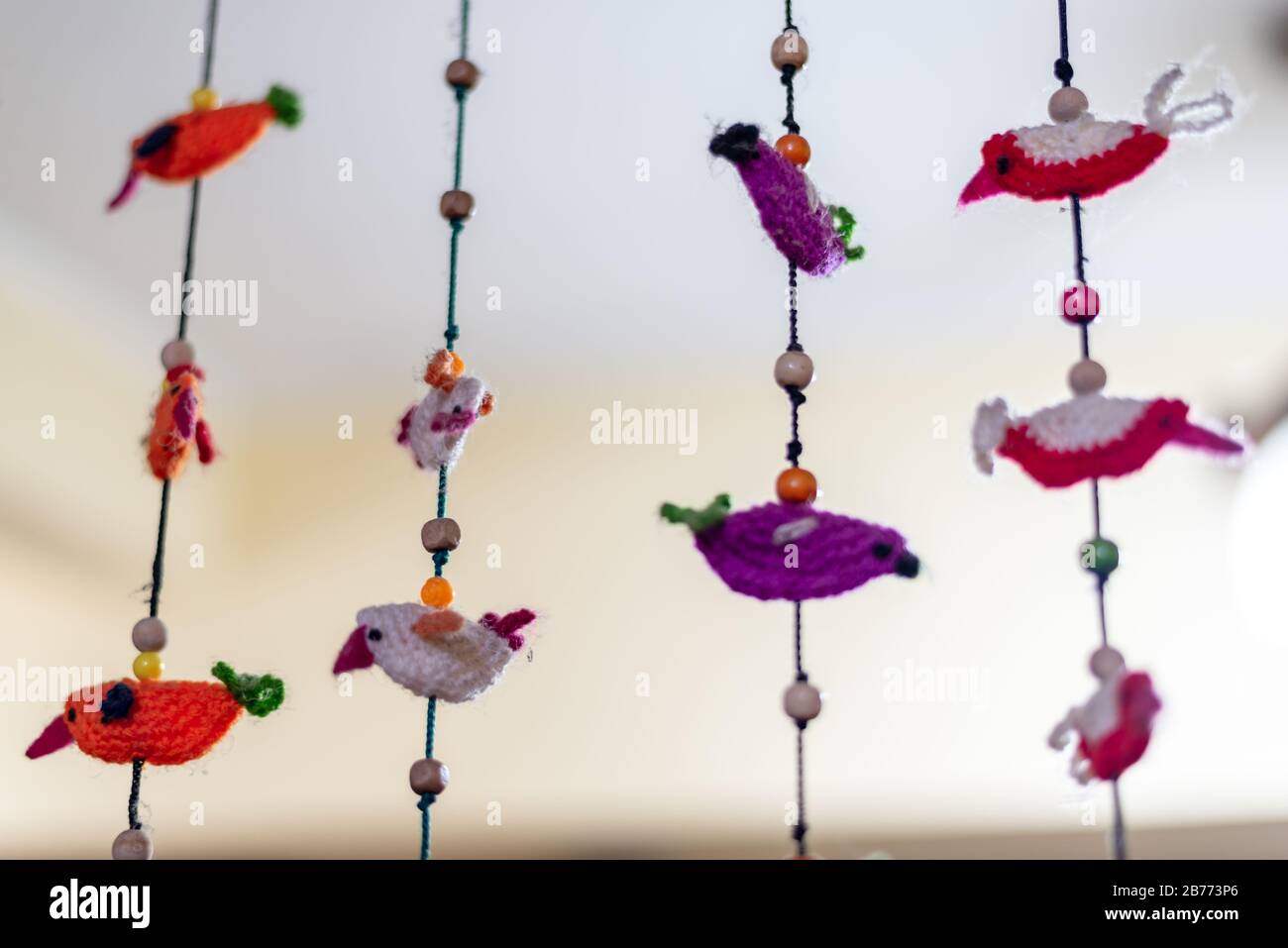 Wool handcrafted birds on strings Stock Photo - Alamy